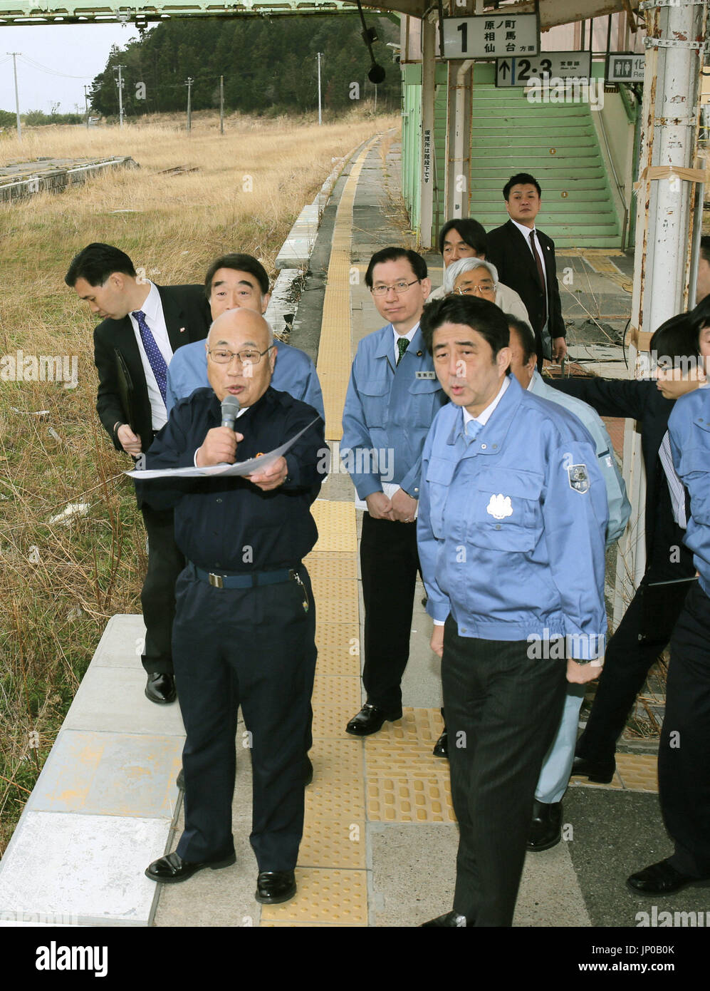 TOMIOKA, Japan - Prime Minister Shinzo Abe (R) listens as Katsuya Endo (L), mayor of Tomioka ...