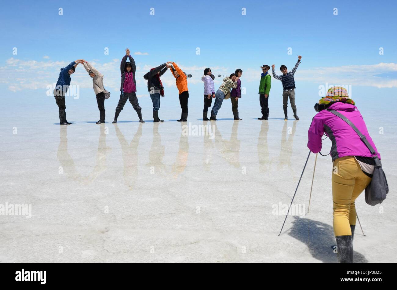 UYUNI, Bolivia - Photo shows Japanese tourists posing for photos so ...