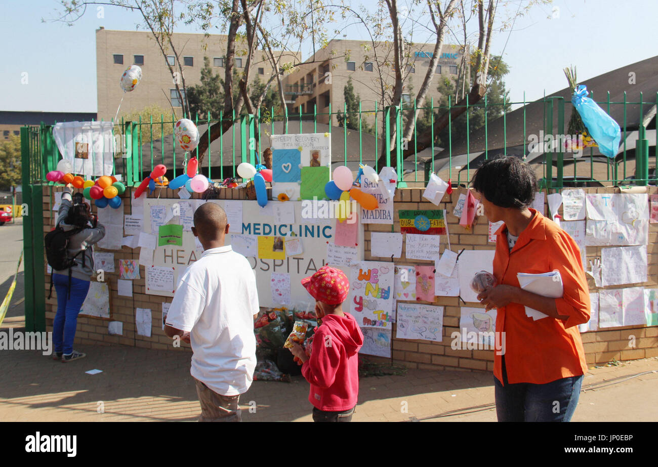 PRETORIA, South Africa - People look at messages hoping for the ...