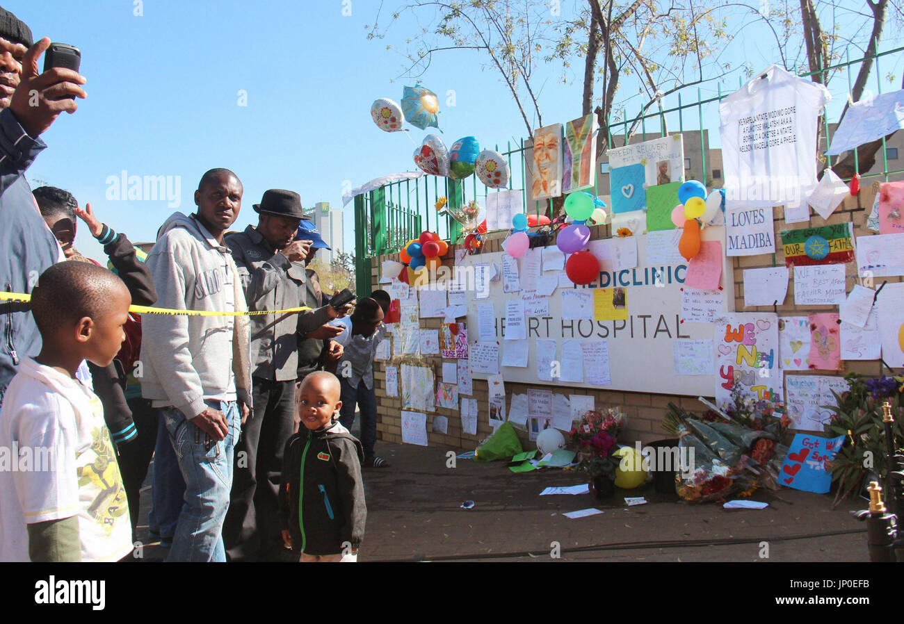 PRETORIA, South Africa - People stand near messages expressing hope for ...