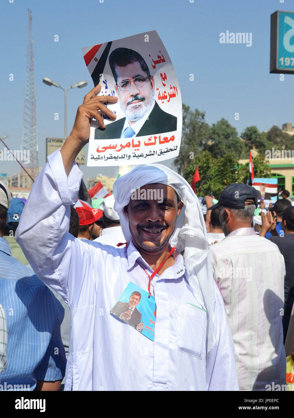 CAIRO, Egypt - A man holds up a portrait of Egyptian President Mohammed ...