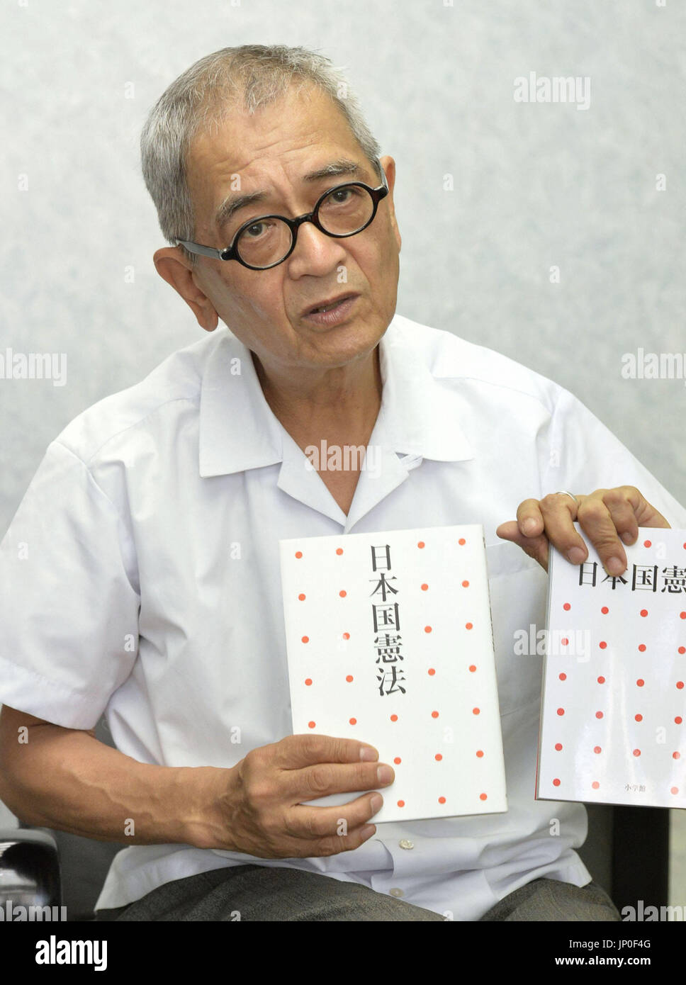TOKYO, Japan - Shuji Shimamoto holds copies of Shogakukan Inc.'s long ...