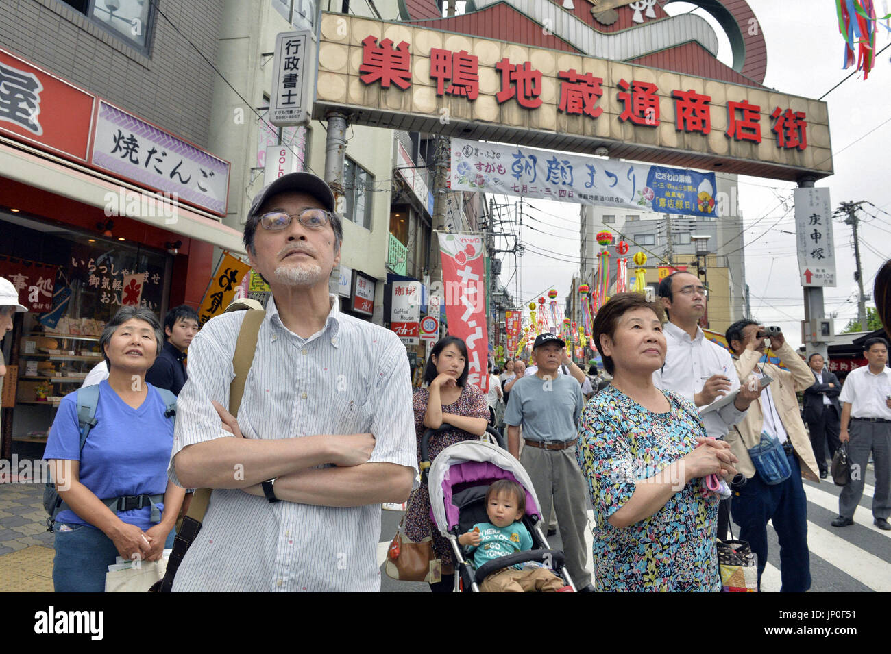 TOKYO, Japan - People listen to a stump speech by a candidate in Tokyo ...