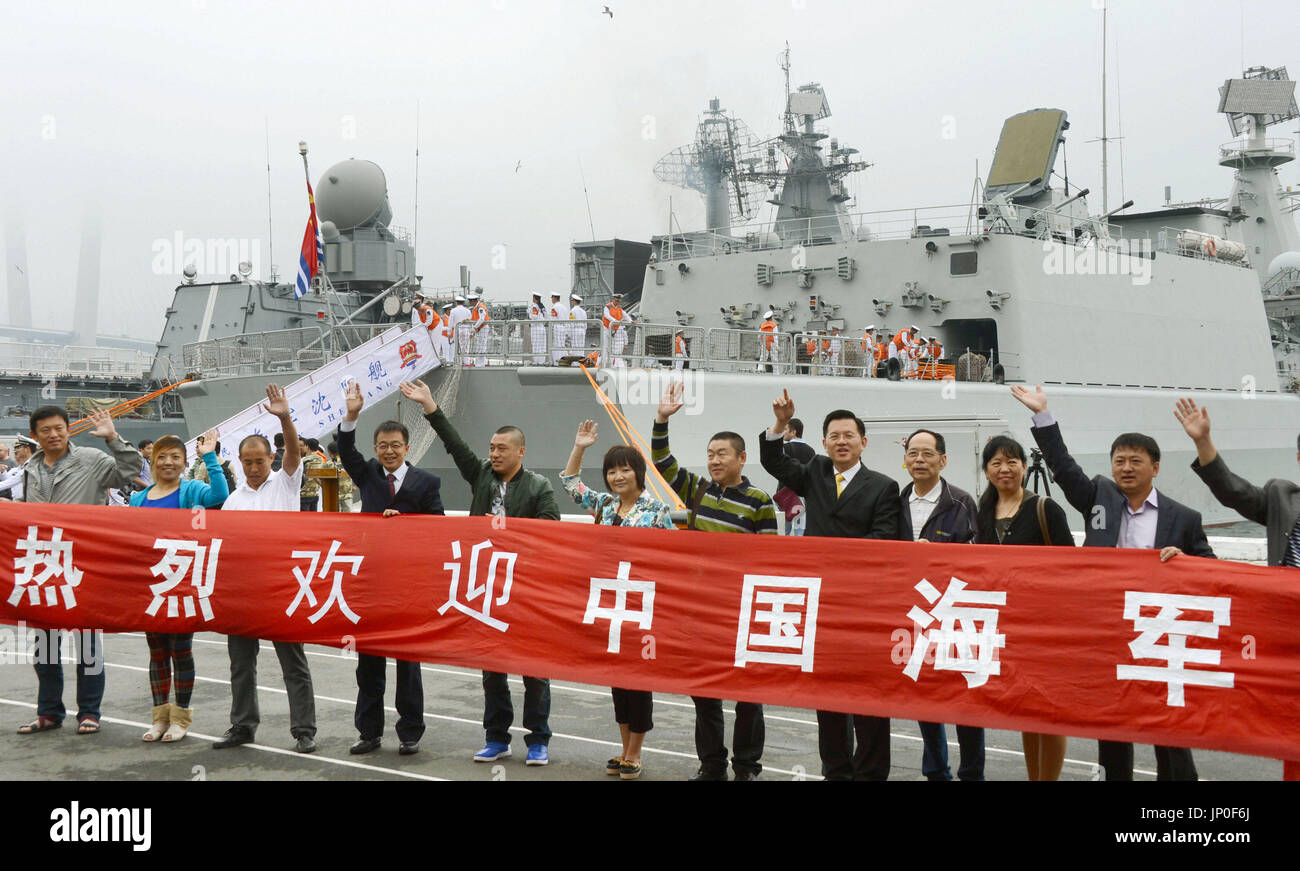 VLADIVOSTOK, Russia - Chinese nationals hold a banner to welcome the ...