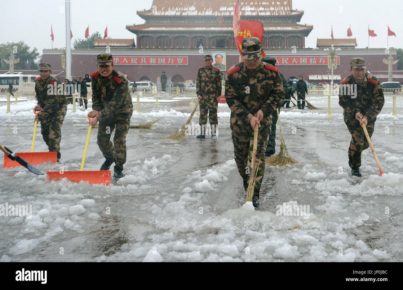 BEIJING, China - Chinese police officers shovel snow at Tiananmen ...
