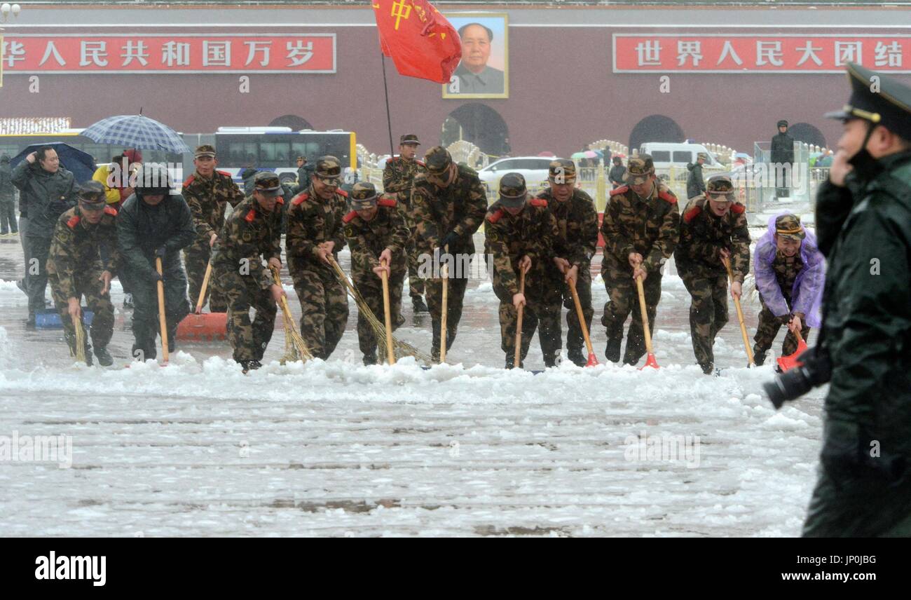 BEIJING, China - Chinese police officers shovel snow at Tiananmen ...