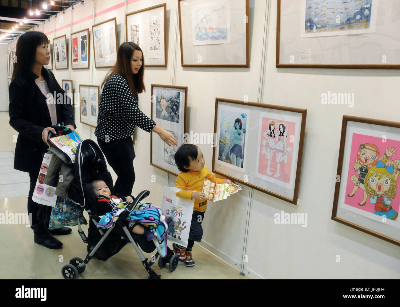 YONAGO, Japan - Visitors view works by manga artists on display at the ...