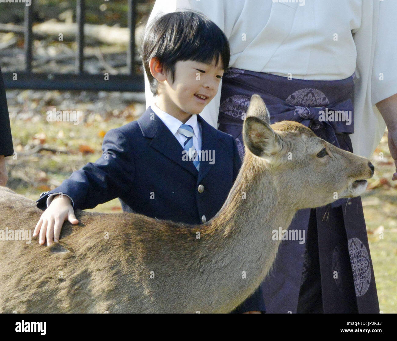 NARA, Japan - Prince Hisahito strokes a deer at Nara Park in Nara City ...