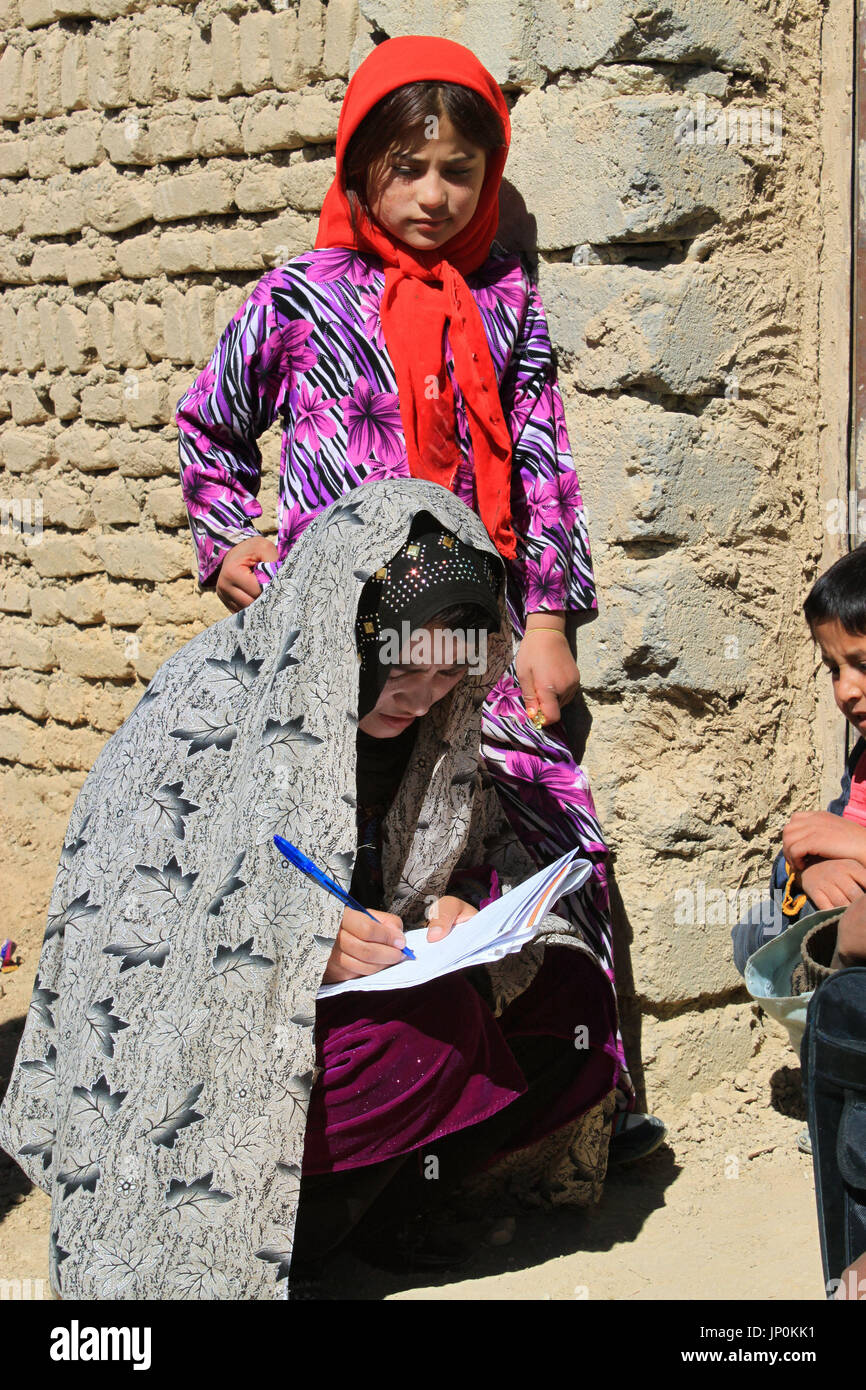 CHAGHCHARAN, Afghanistan - Curious neighborhood children gather as a ...