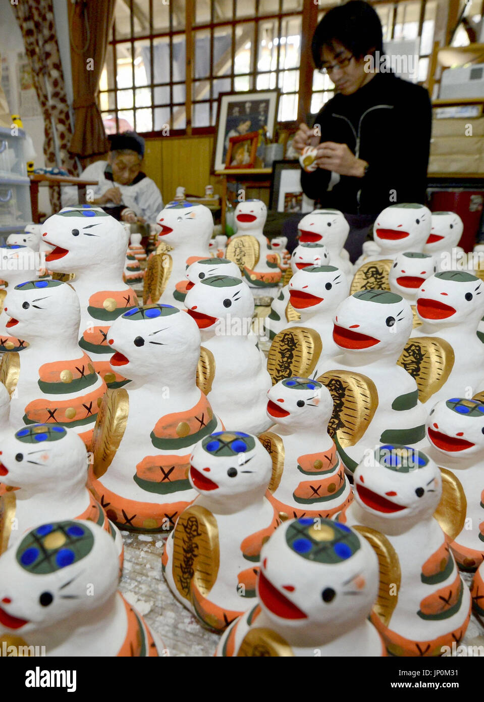 KORIYAMA, Japan - Snake papier-mache folk crafts are made at a workshop ...