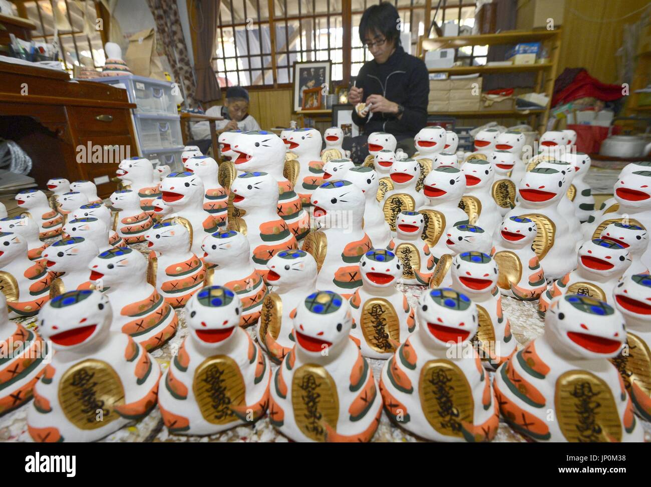 KORIYAMA, Japan - Snake papier-mache folk crafts are made at a workshop ...