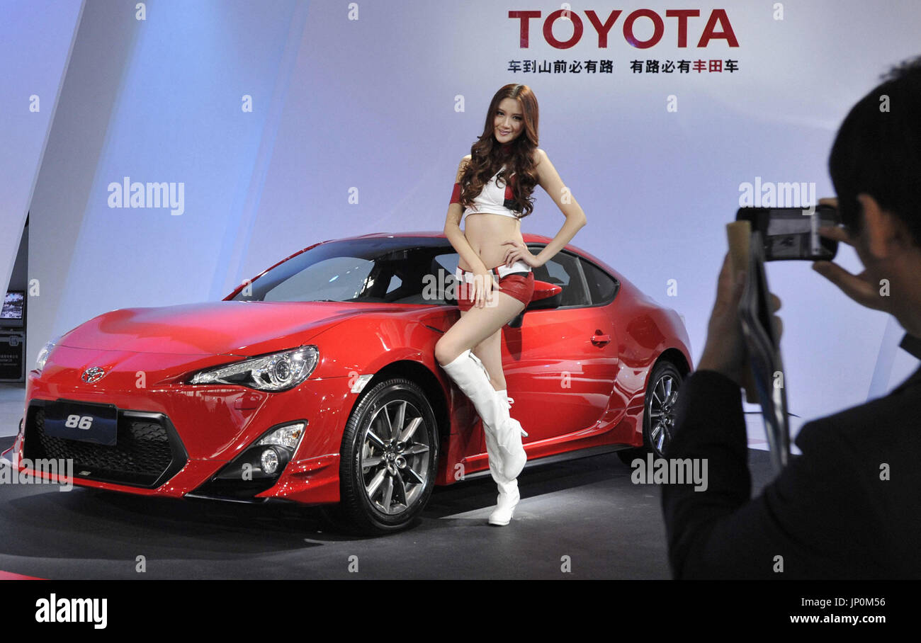 GUANGZHOU, China - A model poses in the Toyota Motor Corp. exhibition space at an international ...