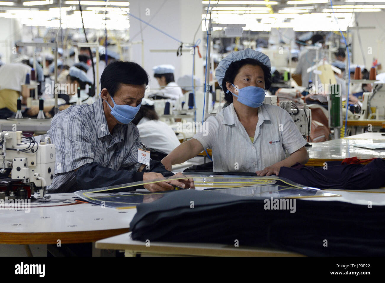 TOKYO, Japan - An October 2012 file photo shows workers at a garment ...