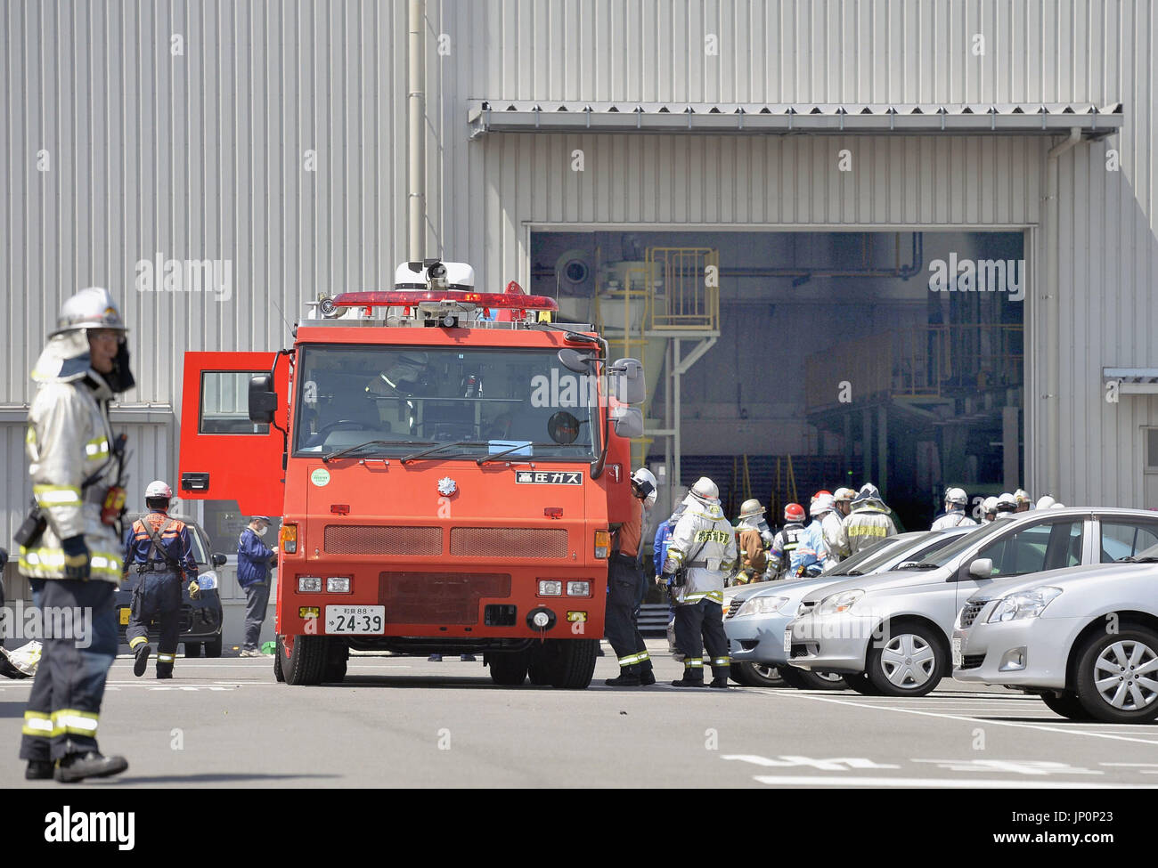 OSAKA, Japan - Firefighters gather at a factory of copper product maker ...