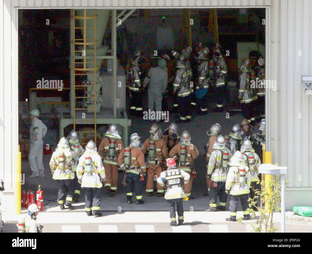 OSAKA, Japan - Firefighters gather at a factory of copper product maker ...