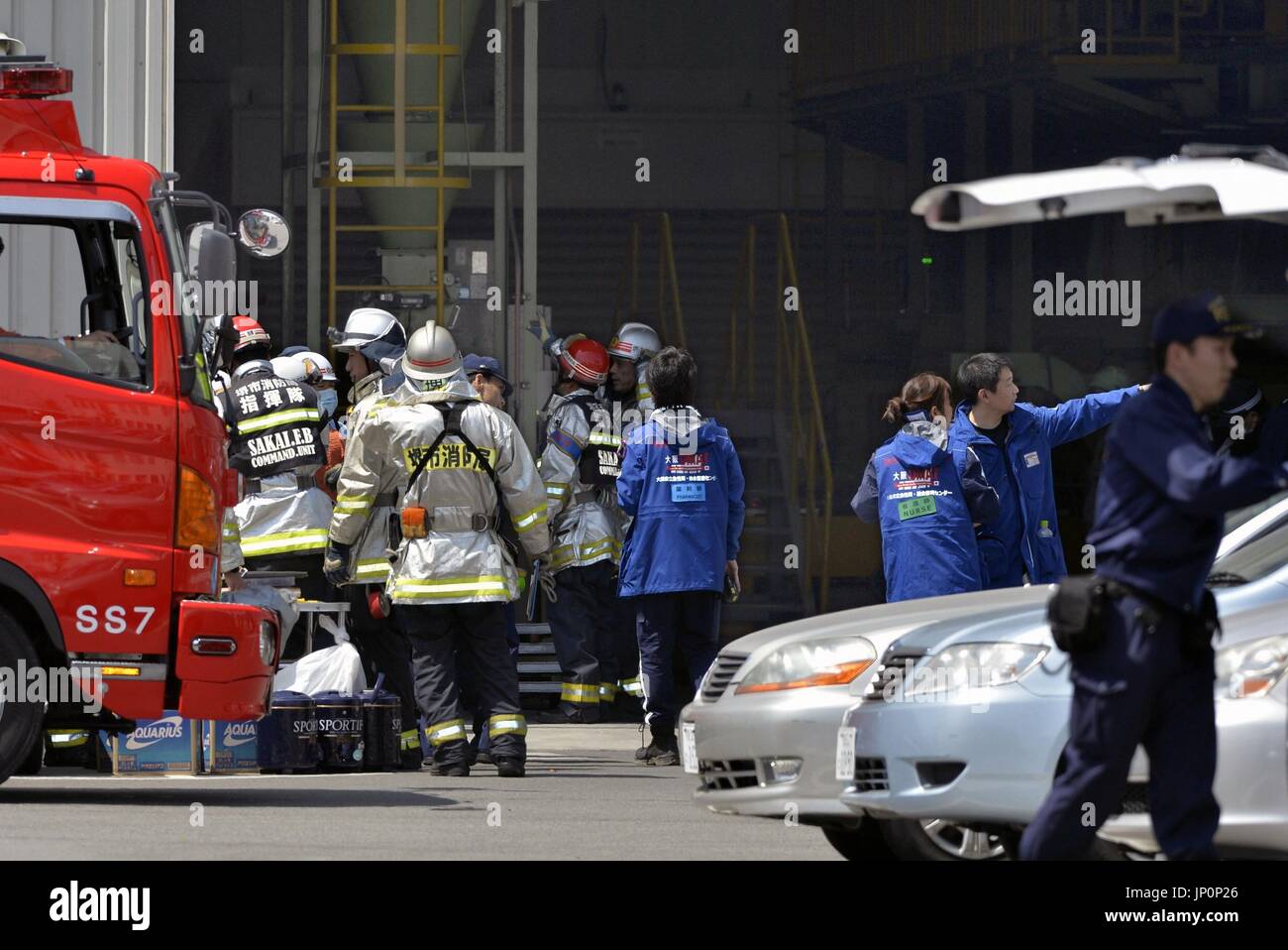 OSAKA, Japan - Firefighters gather at a factory of copper product maker ...