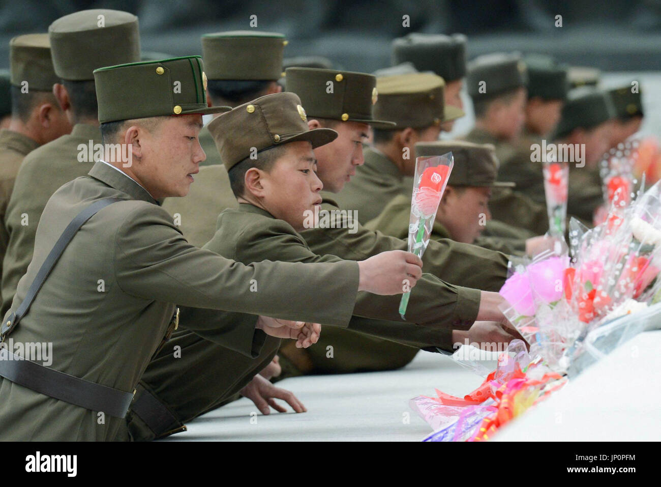 PYONGYANG, North Korea - Soldiers lay flowers on Mansu Hill in ...