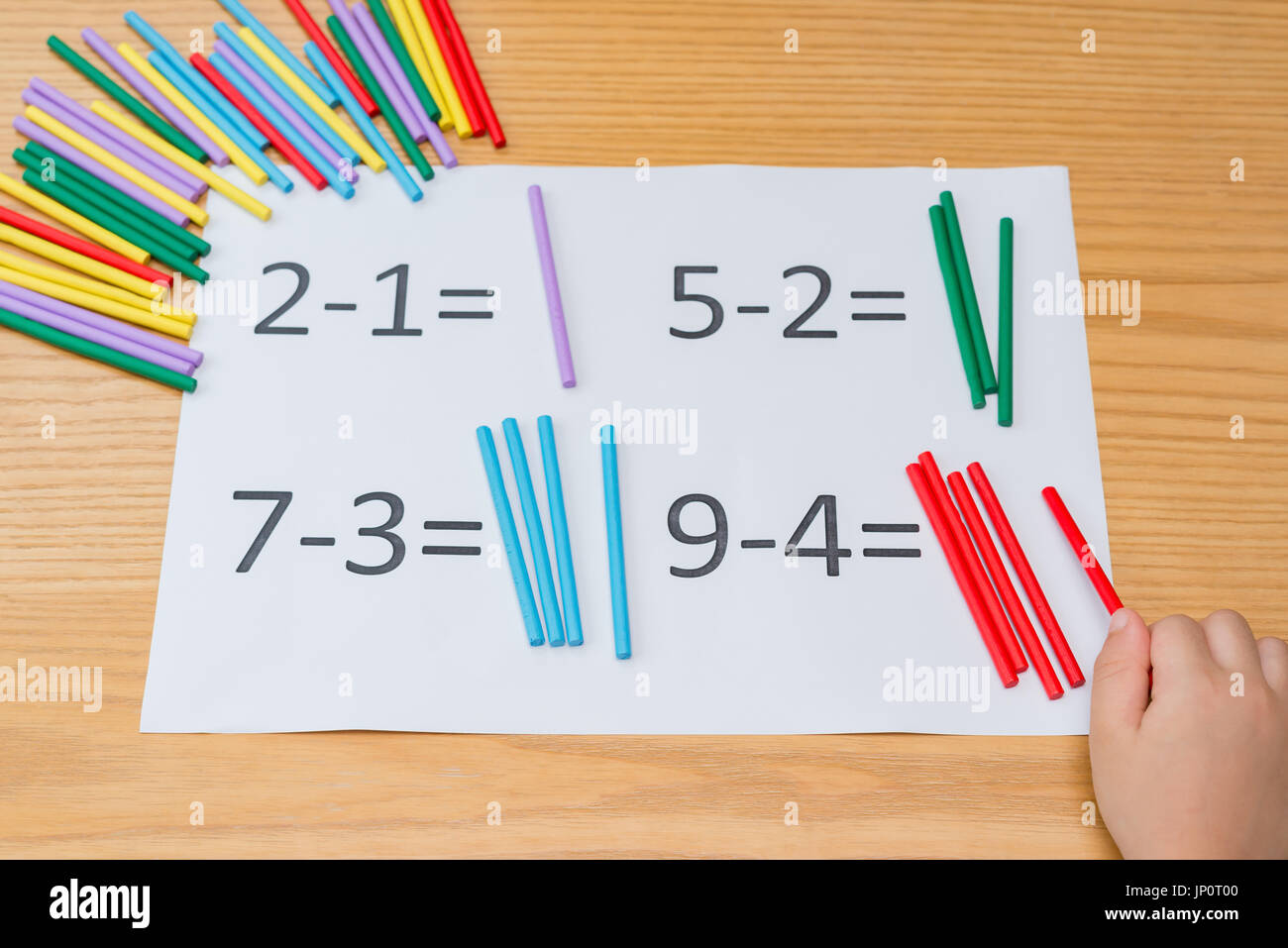 kid learning simple subtraction by counting numbers of sticks Stock ...