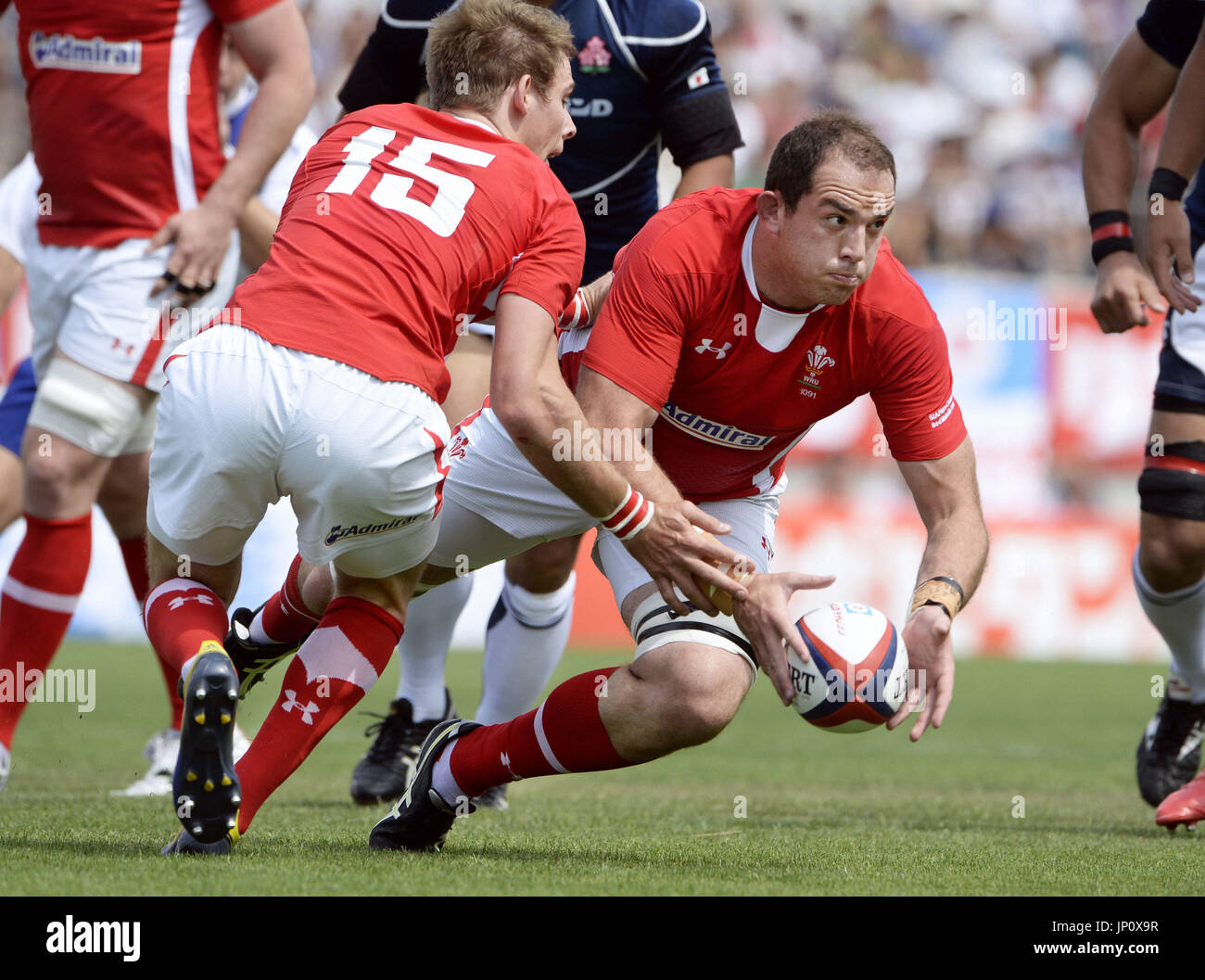 OSAKA, Japan - Lou Reed (R) of Wales makes a pass during the first half ...
