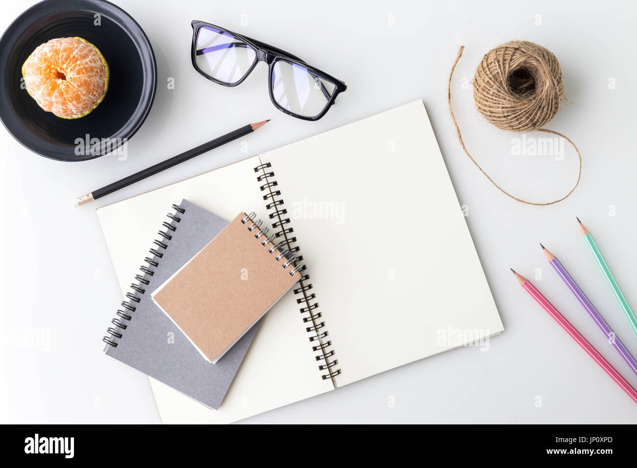 Modern white office desk top table with notebook, note, a cup of coffee ...