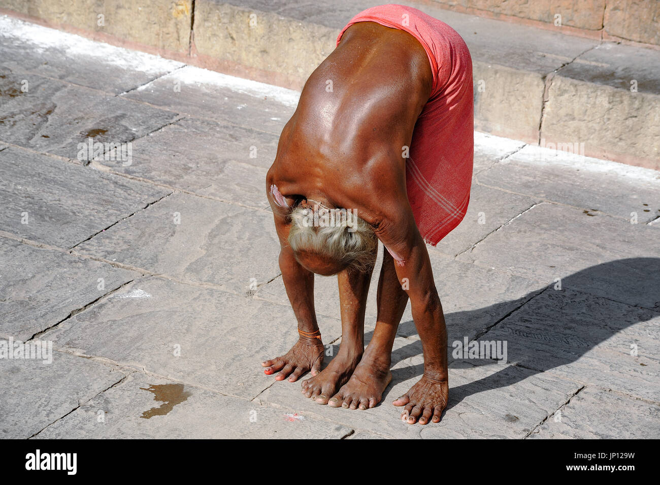A Holy Man practices yoga with morning salutations Stock Photo - Alamy