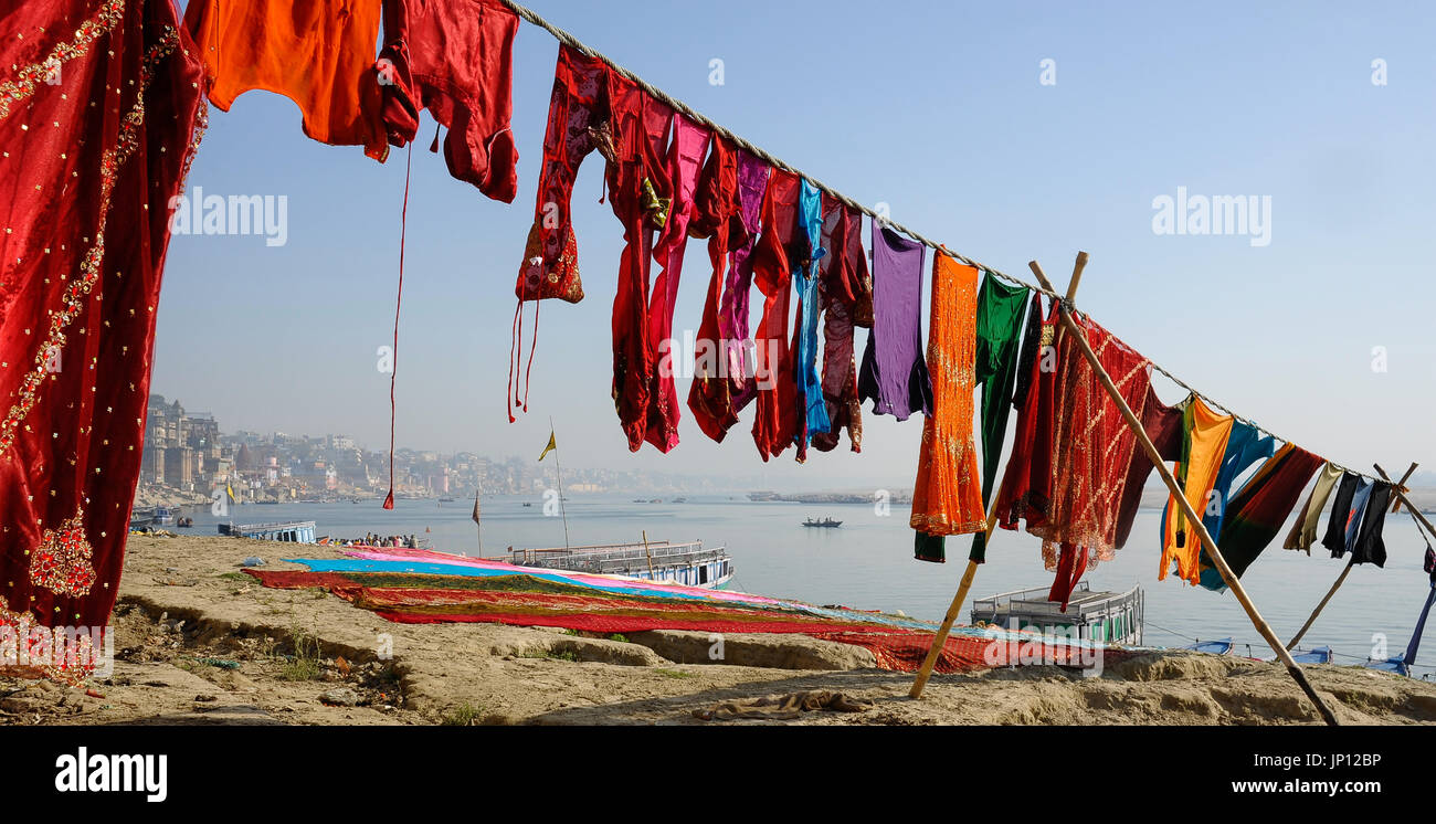 Vibrant clothing hanging to dry beside the Ganges in Varanasi Stock ...