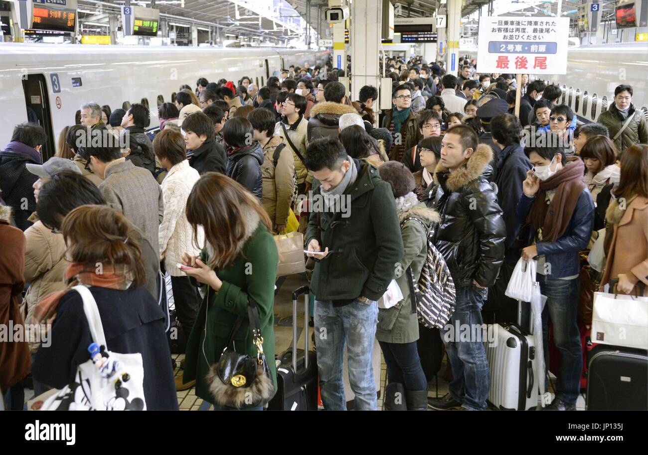 TOKYO, Japan - A shinkansen bullet train line platform is crowded with passengers at JR Tokyo ...