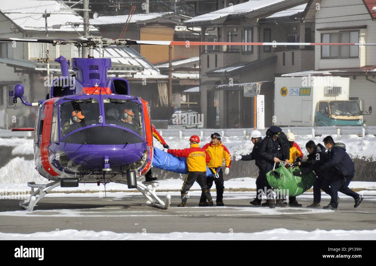 TAKAYAMA, Japan - Police officers transport a climber (R) recovered in ...
