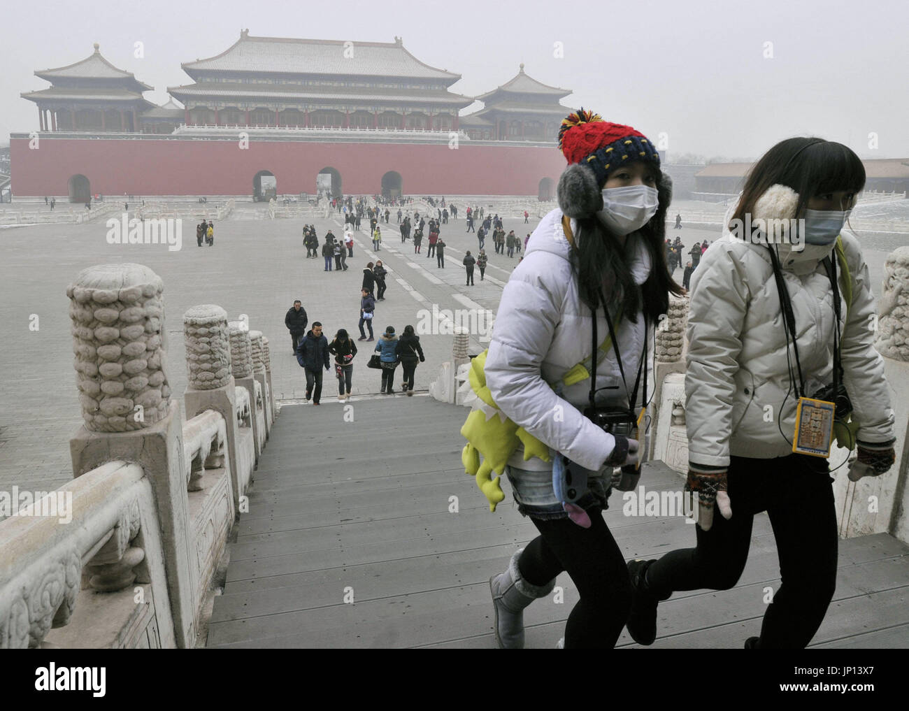 BEIJING, China - Women wear masks due to air pollution while ...