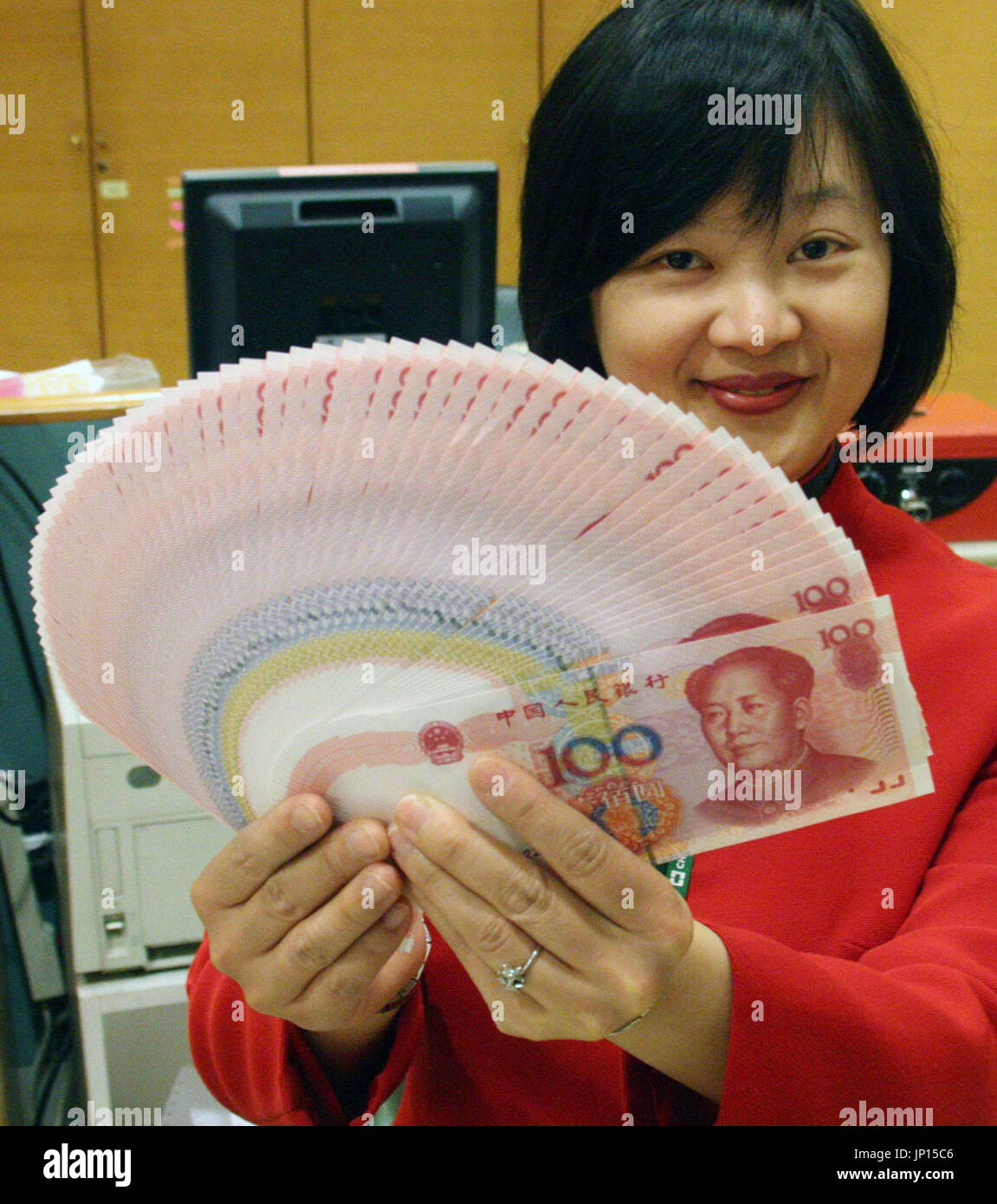 TAIPEI, Taiwan - An employee holds Chinese yuan bills at Chinatrust ...