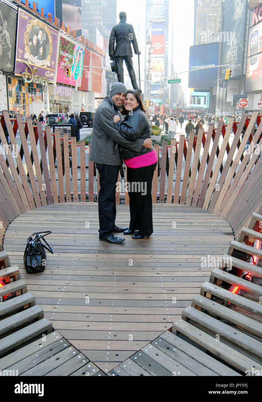 NEW YORK, United States - A couple hugs each other on a heart-shaped ...
