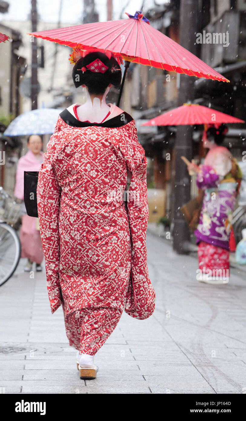 KYOTO, Japan - An apprentice geisha heads for a photo shoot in light ...