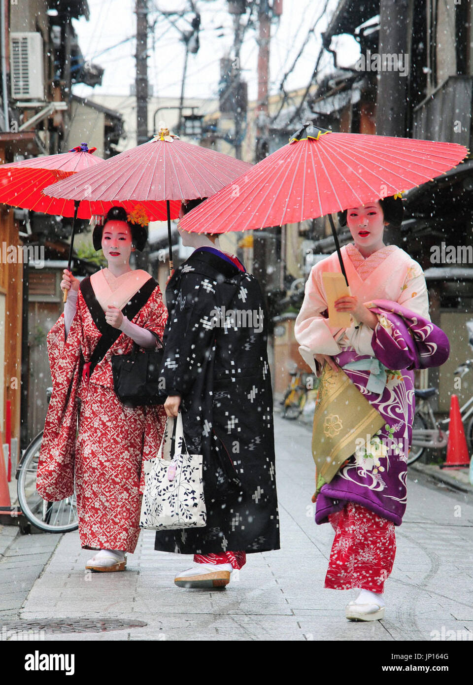 KYOTO, Japan - Apprentice geisha head for a photo shoot in light snow ...
