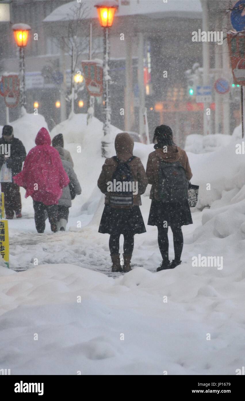 AOMORI, Japan - People walk on a snow-covered sidewalk in Aomori ...