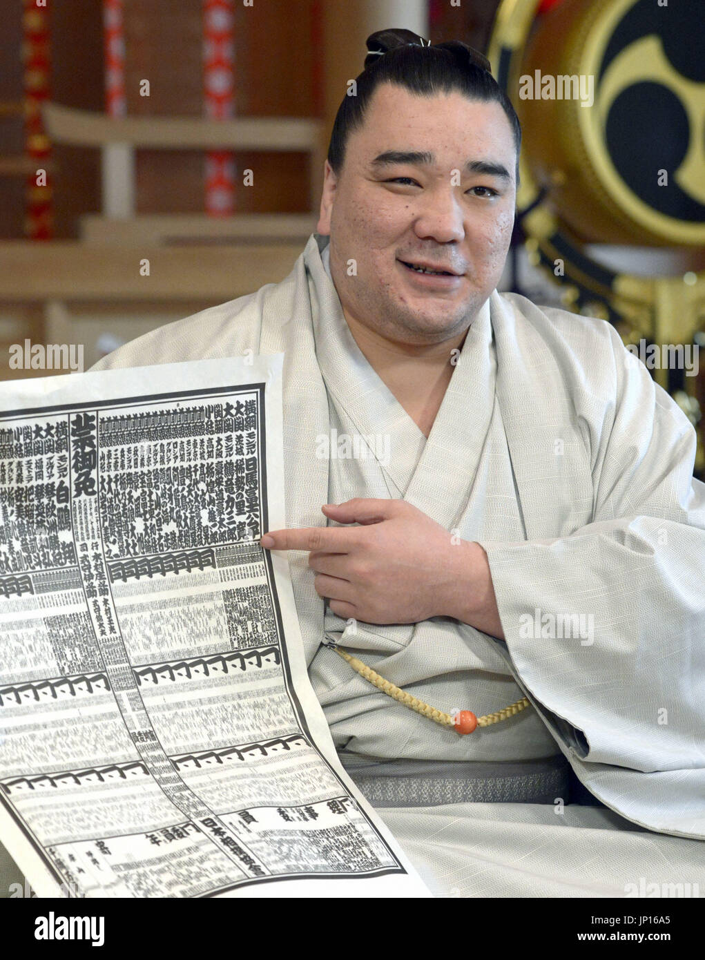 OSAKA, Japan - Yokozuna Harumafuji points to his name on a new sumo ...