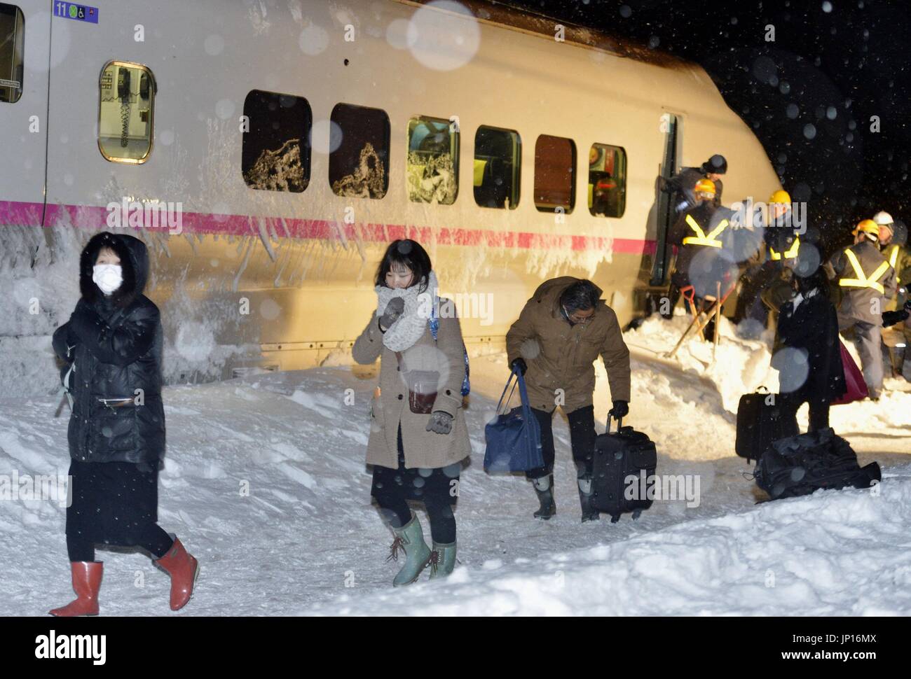 DAISEN, Japan - Passengers walk to buses in the snow in Daisen, Akita ...