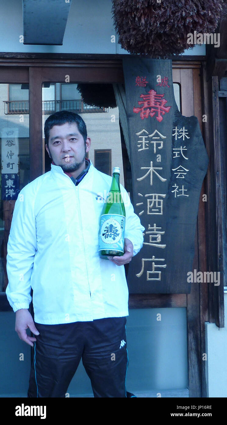 NAGAI, Japan - Daisuke Suzuki, a Japanese sake brewer, holds a bottle ...