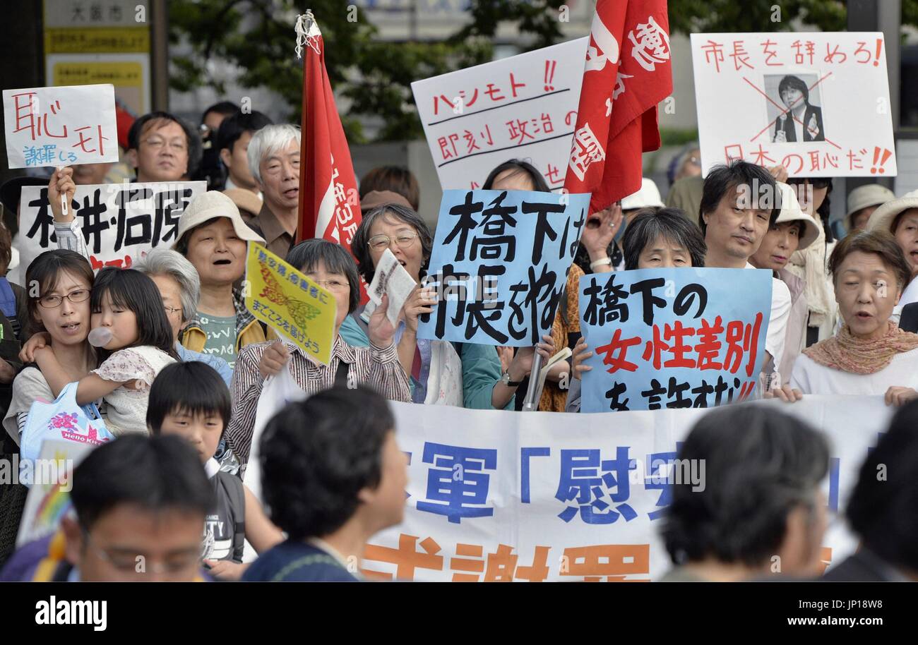 OSAKA, Japan - People hold a rally in front of the Osaka city offices ...