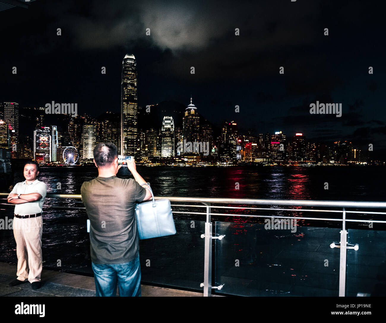tourist walking on the waterfront at night Stock Photo - Alamy