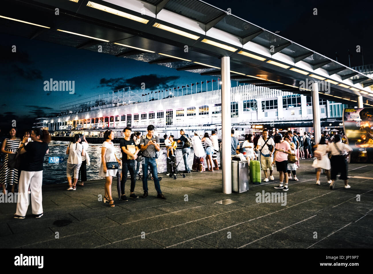 tourist walking on the waterfront at night Stock Photo - Alamy