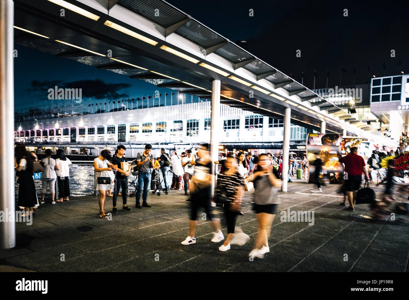 tourist walking on the waterfront at night Stock Photo - Alamy