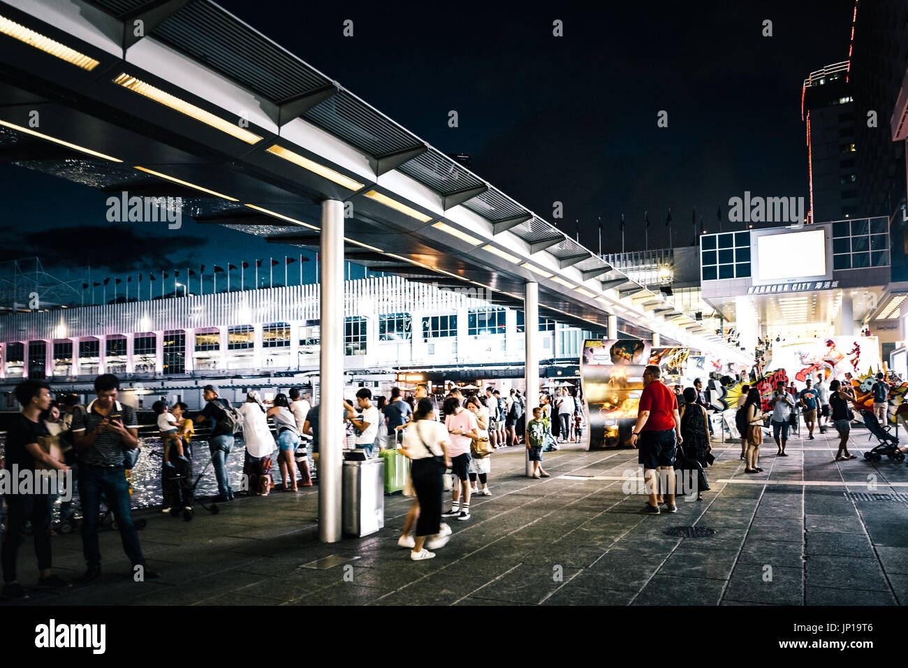 tourist walking on the waterfront at night Stock Photo - Alamy