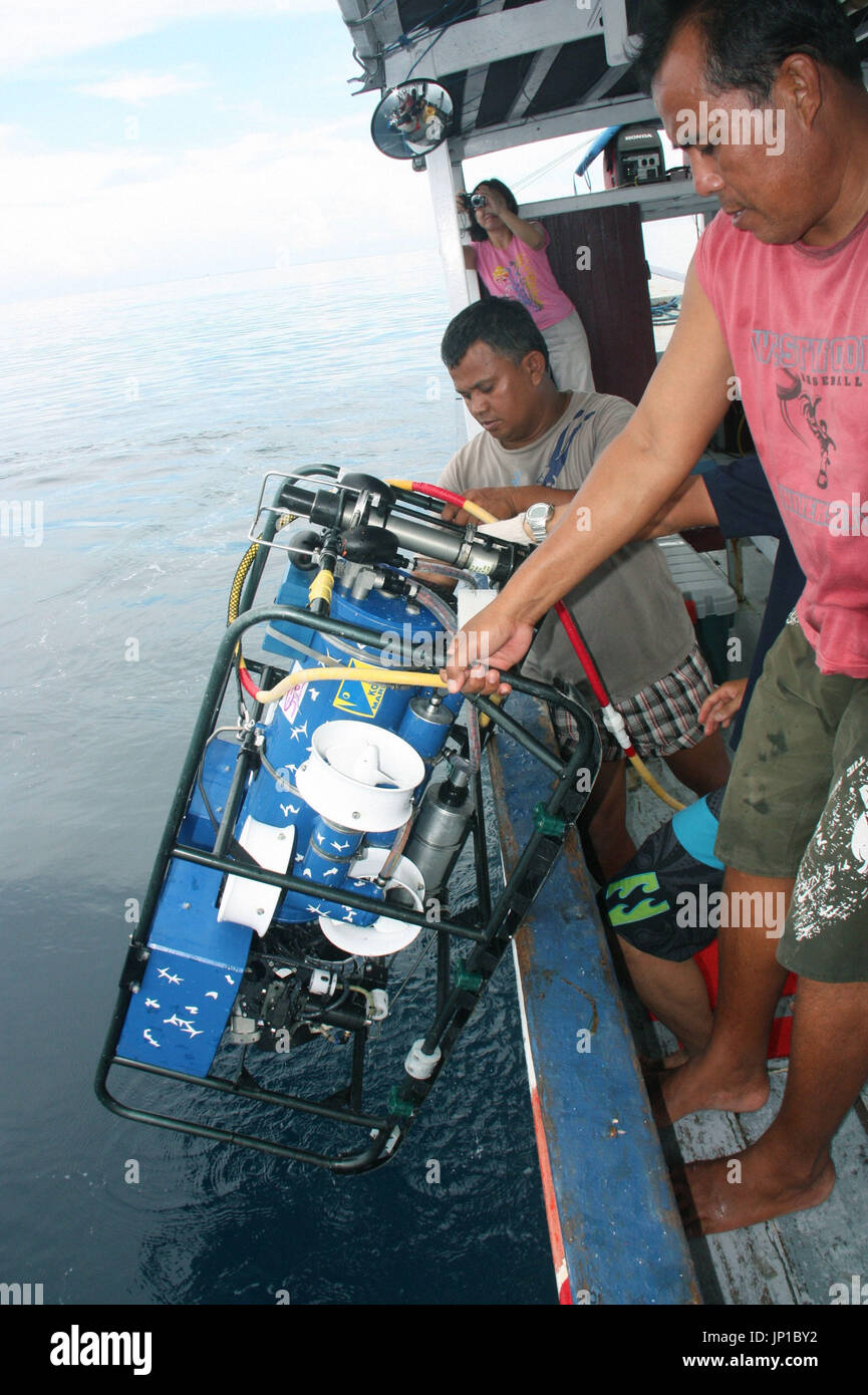 MANADO, Indonesia - Researchers pull an underwater camera out of the ...