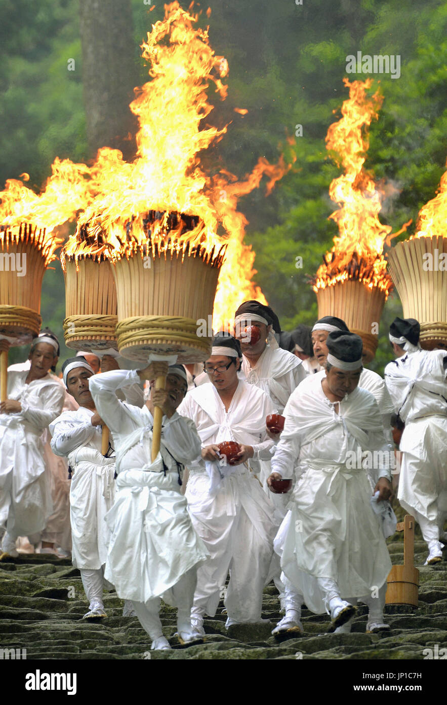 NACHIKATSUURA, Japan - Burning torches of cypress wood are carried ...