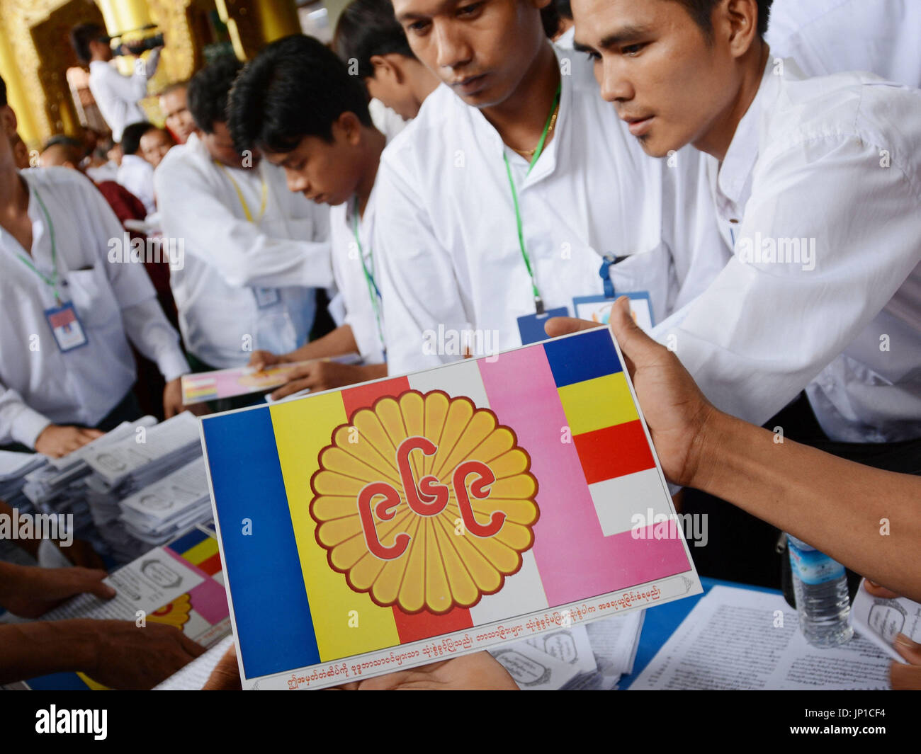 YANGON, Myanmar - Buddhists distribute stickers bearing the figures ...