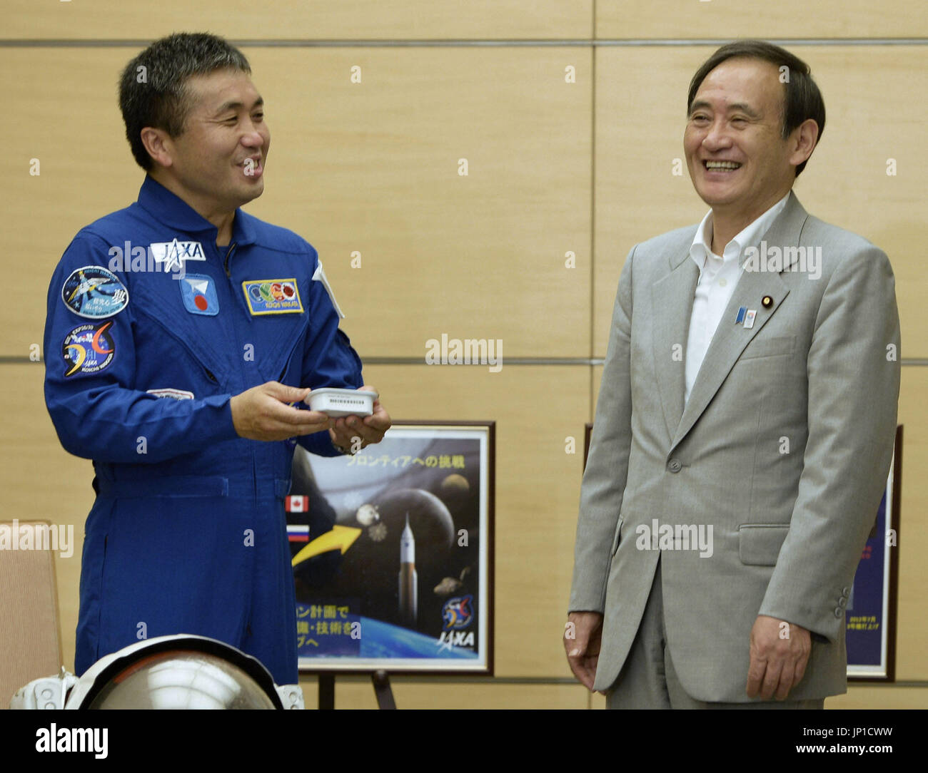 TOKYO, Japan - Japanese astronaut Koichi Wakata (L) presents canned ...