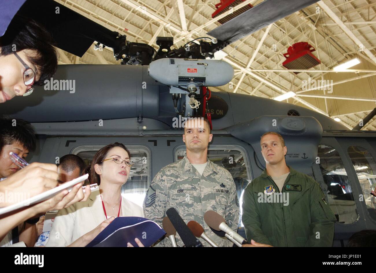 NAHA, Japan - A member of the U.S. Air Force shows reporters an HH-60 ...