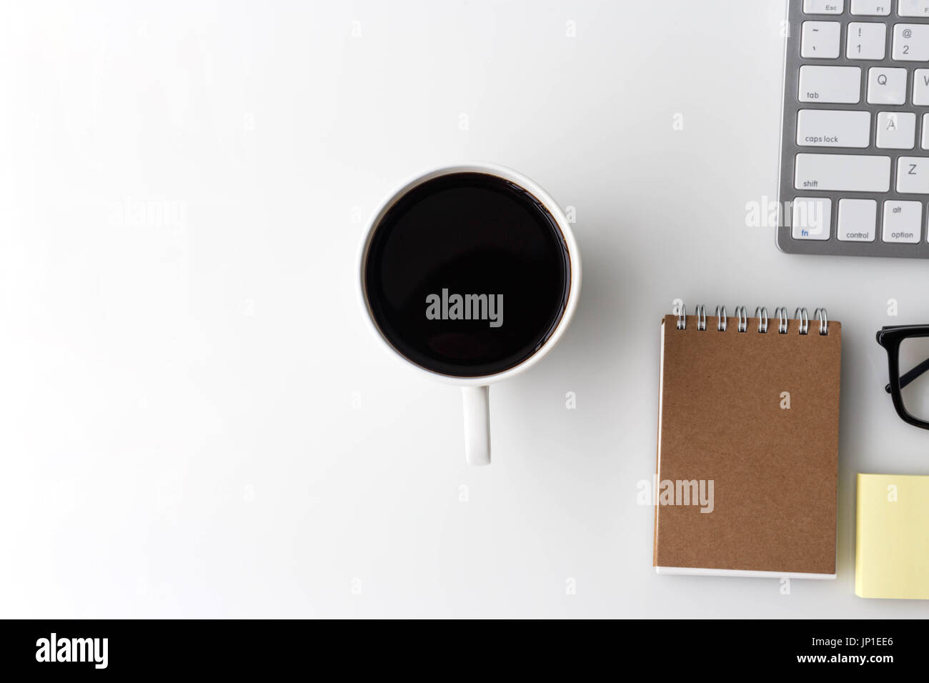 Modern white office desk top table with computer laptop, cup of coffee ...