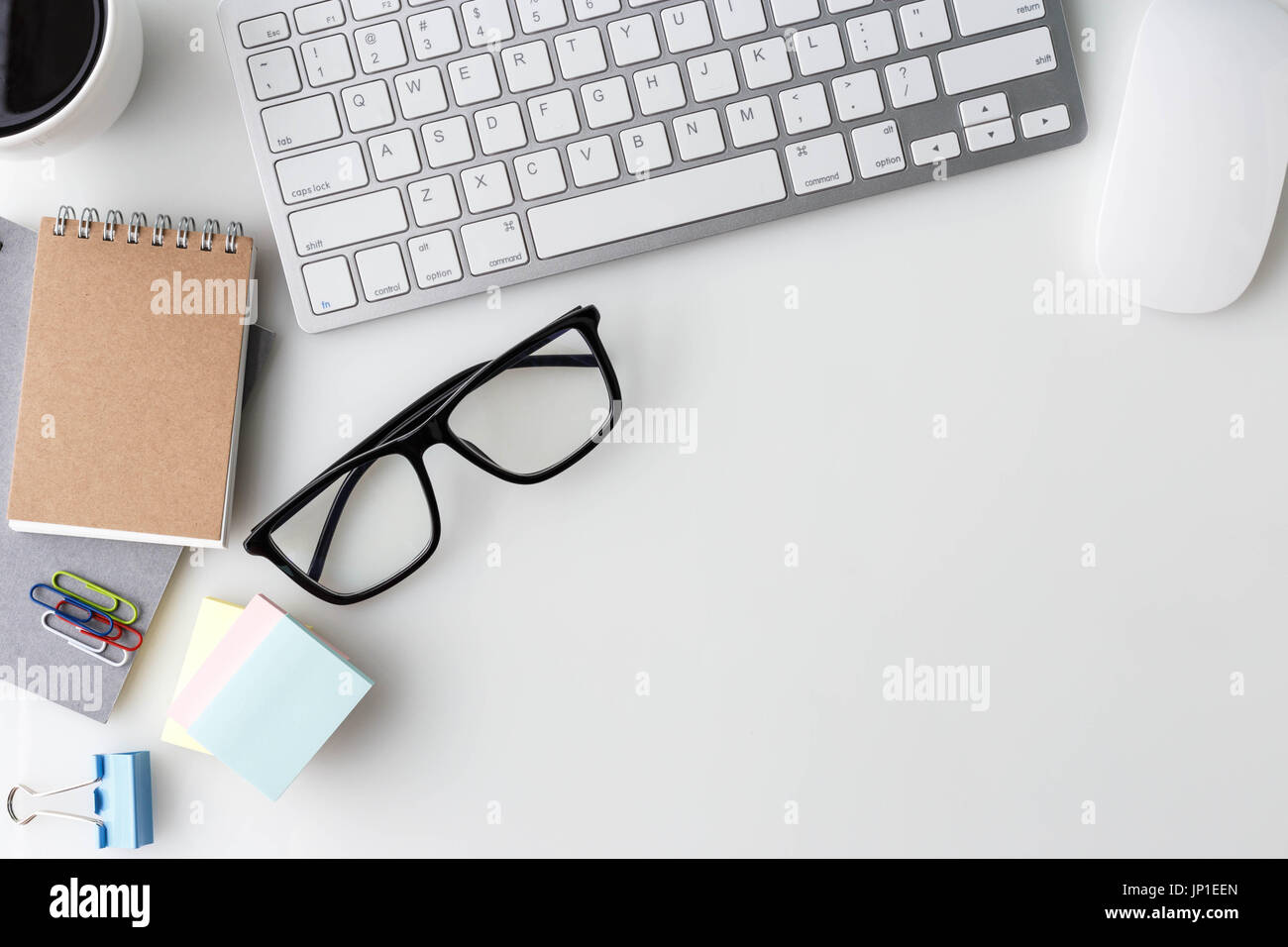 Modern white office desk top table with computer laptop, cup of coffee ...
