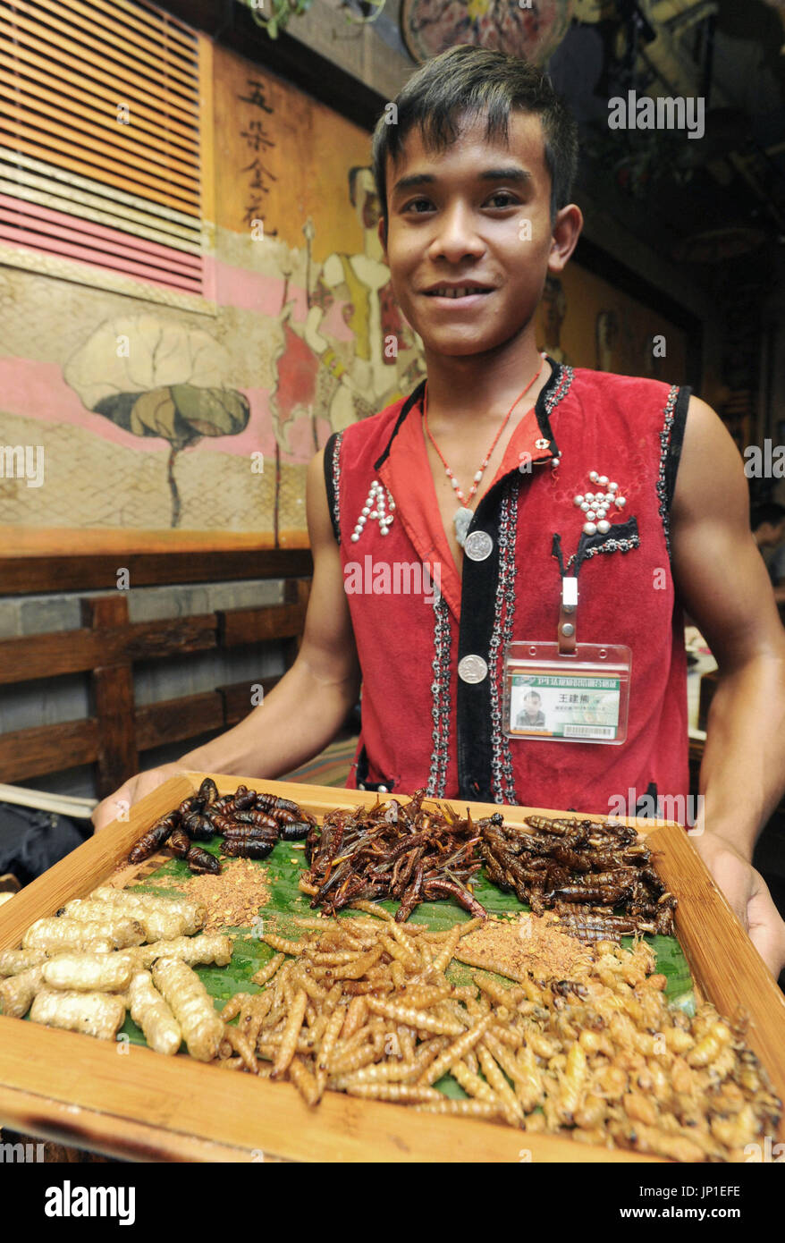 BEIJING, China - An employee at a Beijing restaurant shows one of its ...